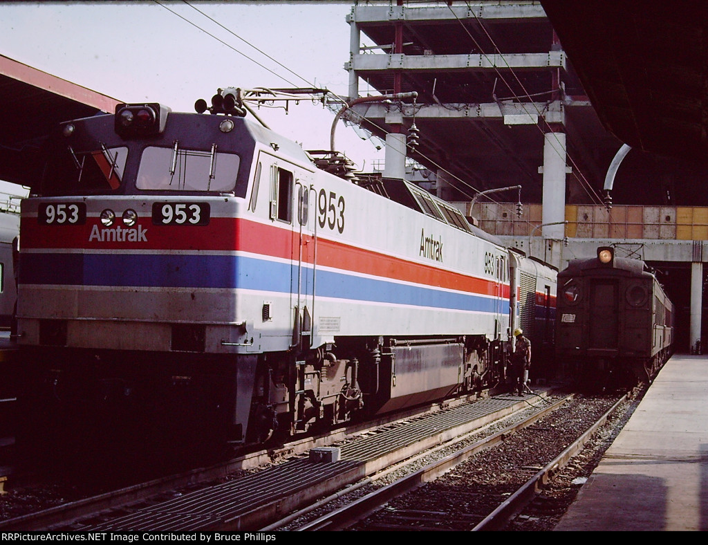 New Amtrak E60 and old MP54 share tracks as Union Station in 1977